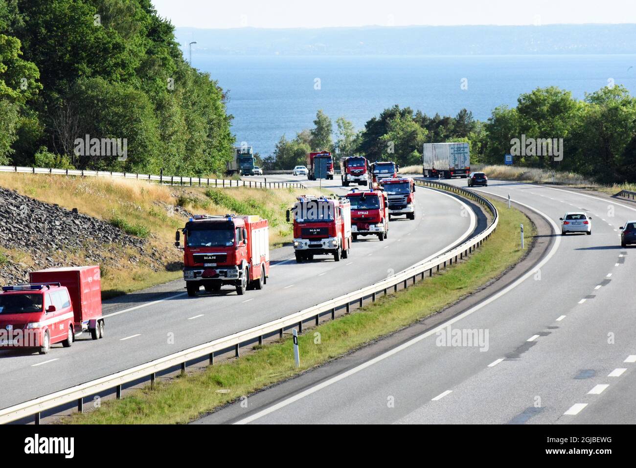 A konvoj of firefighters and theri vehicle from Poland are seen passing ...