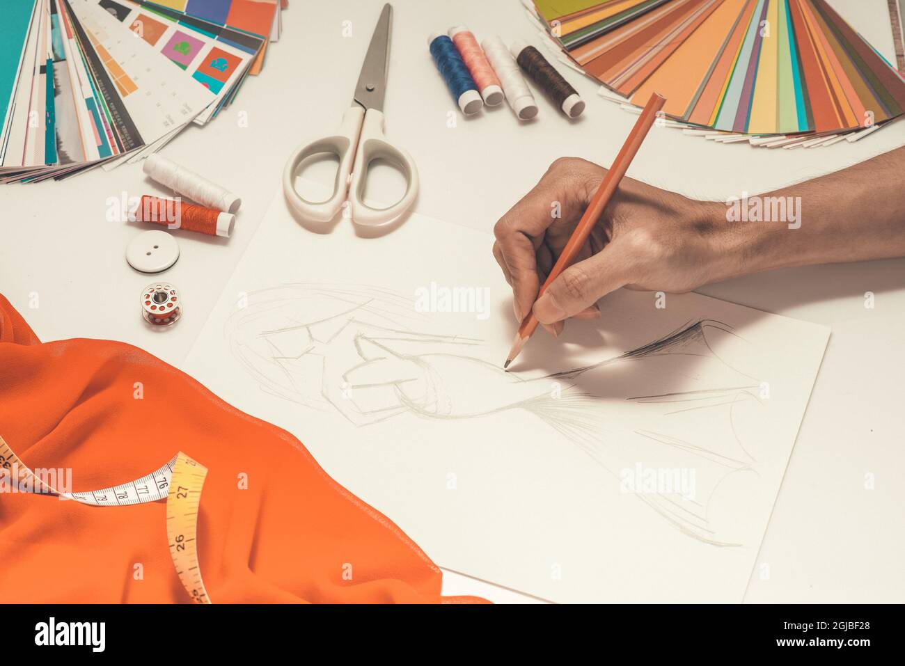 Close-up of designer drawing a fashion sketch Stock Photo - Alamy