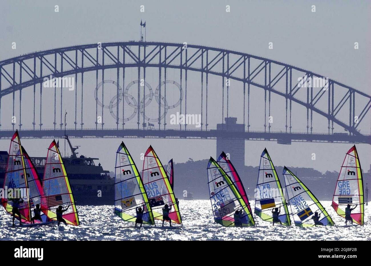 In the shadow of the Sydney Harbour Bridge, wind surfers race in Sydney ...