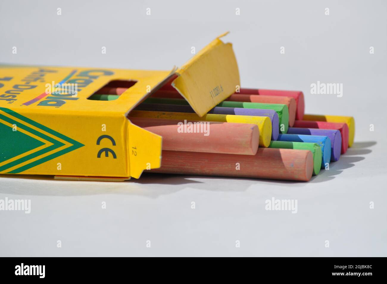 Coloured chalks arranged on a white background. The packaging can be ...