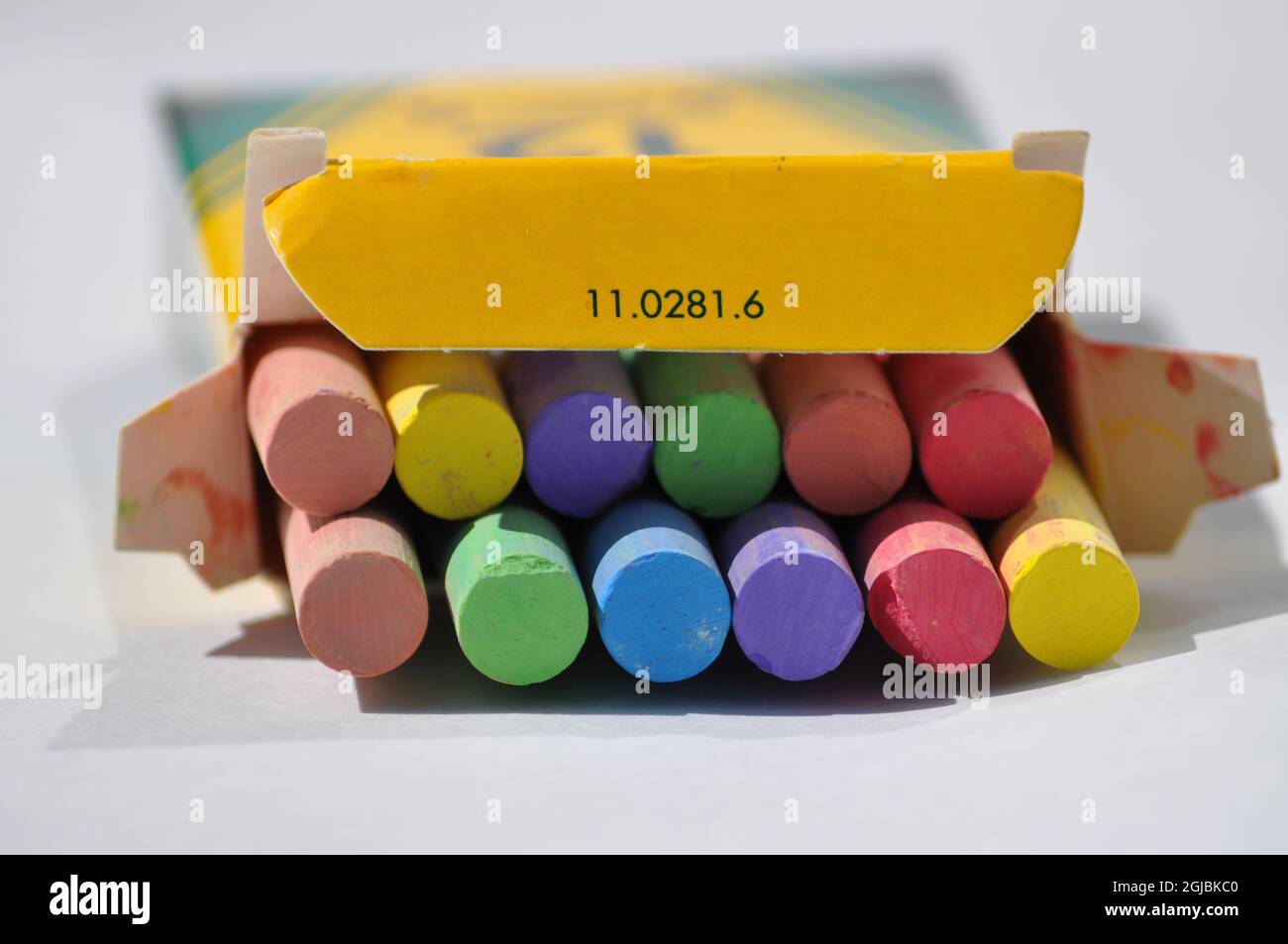 Coloured chalks arranged on a white background. The packaging can be ...