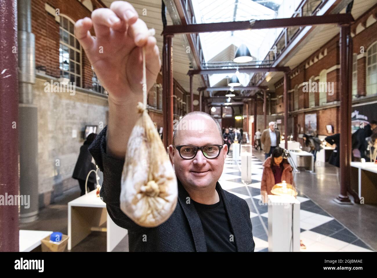 Samuel West, Curator and Chief Disgustologist, holds Su Callu - a cheese made of a kid's milk ...