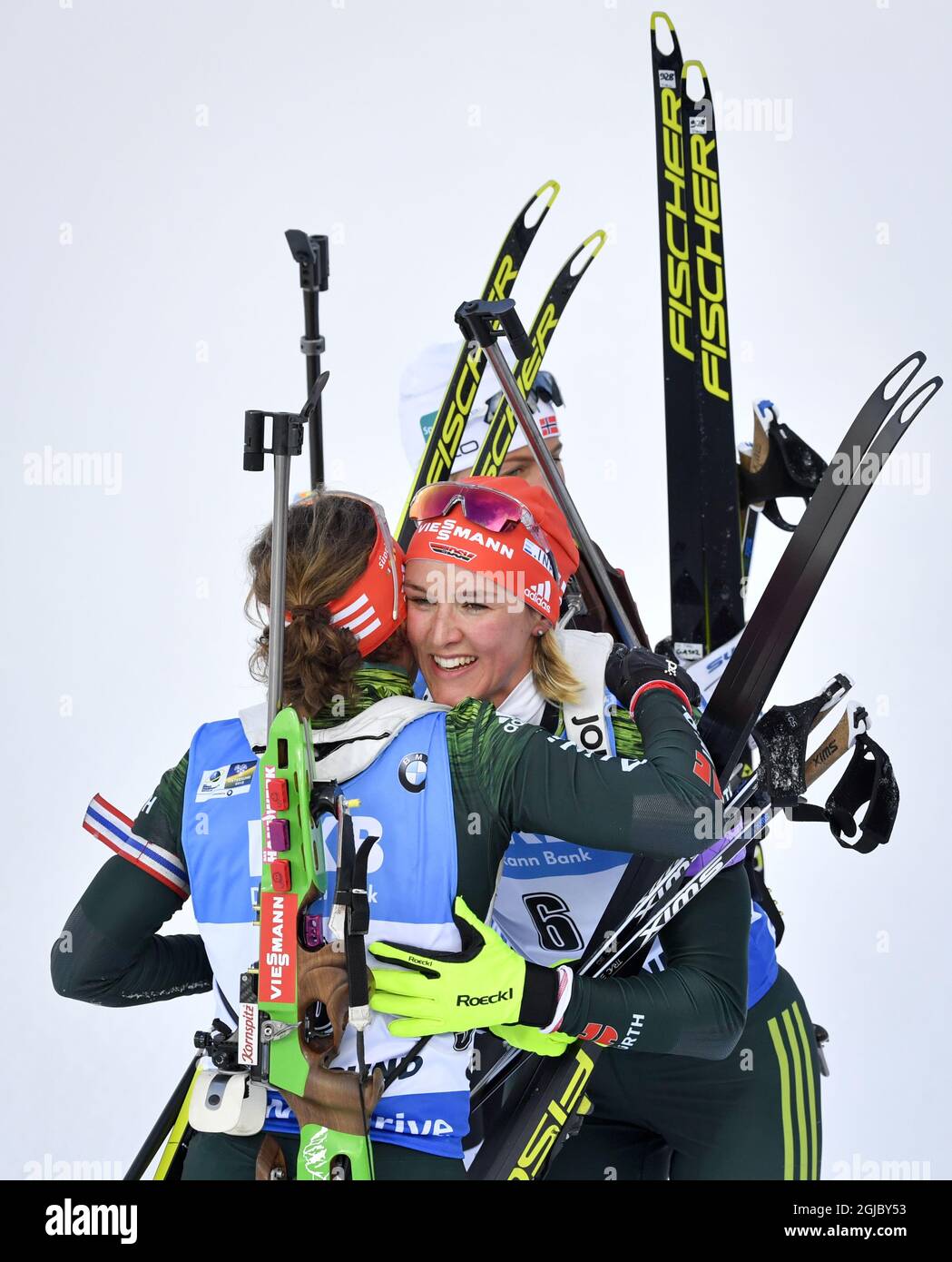 Denise Herrmann (R) of Germany gets a hug after crossing the finish ...