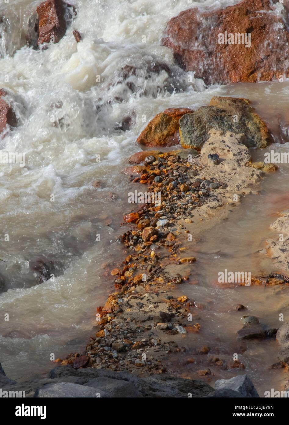 Rushing stream is running downhill near the bubbling Sulphur pools in ...
