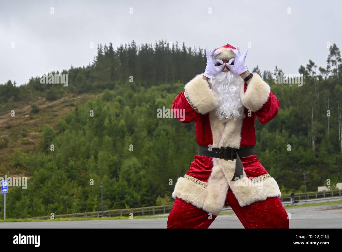 Young male in a Santa Claus suit doing a funny pose outdoors Stock ...