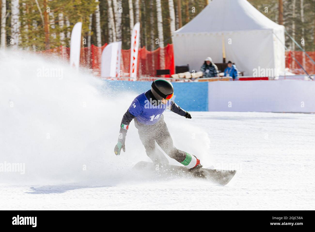 Italian snowboard slow down in finish line behind it splashes of snow ...