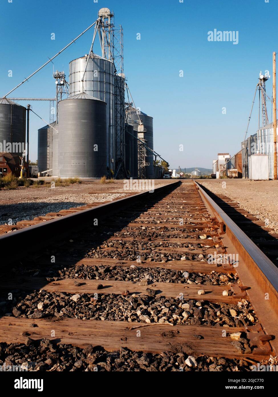 Several tall steel grain silos for storing crops and blue sky with ...