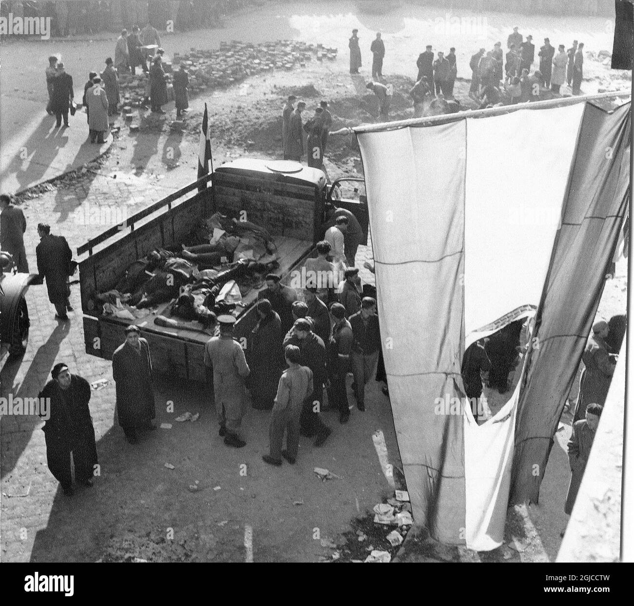 BUDAPEST 1956 Victims of battles are loaded on a truck in Budapest ...