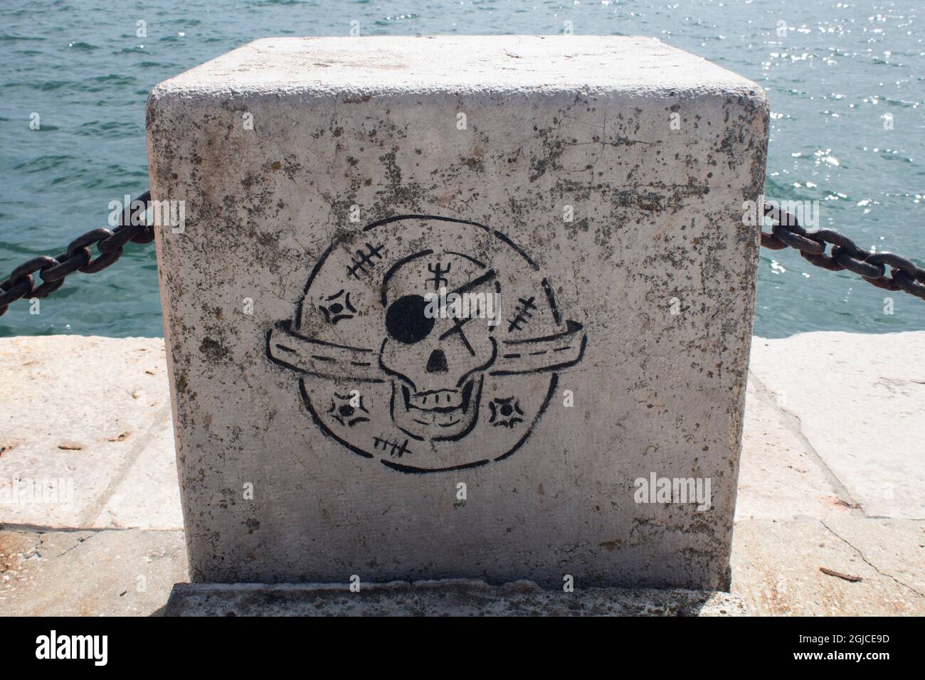 Pirate graffiti on a concrete post by the sea, Setubal Portgual Stock ...
