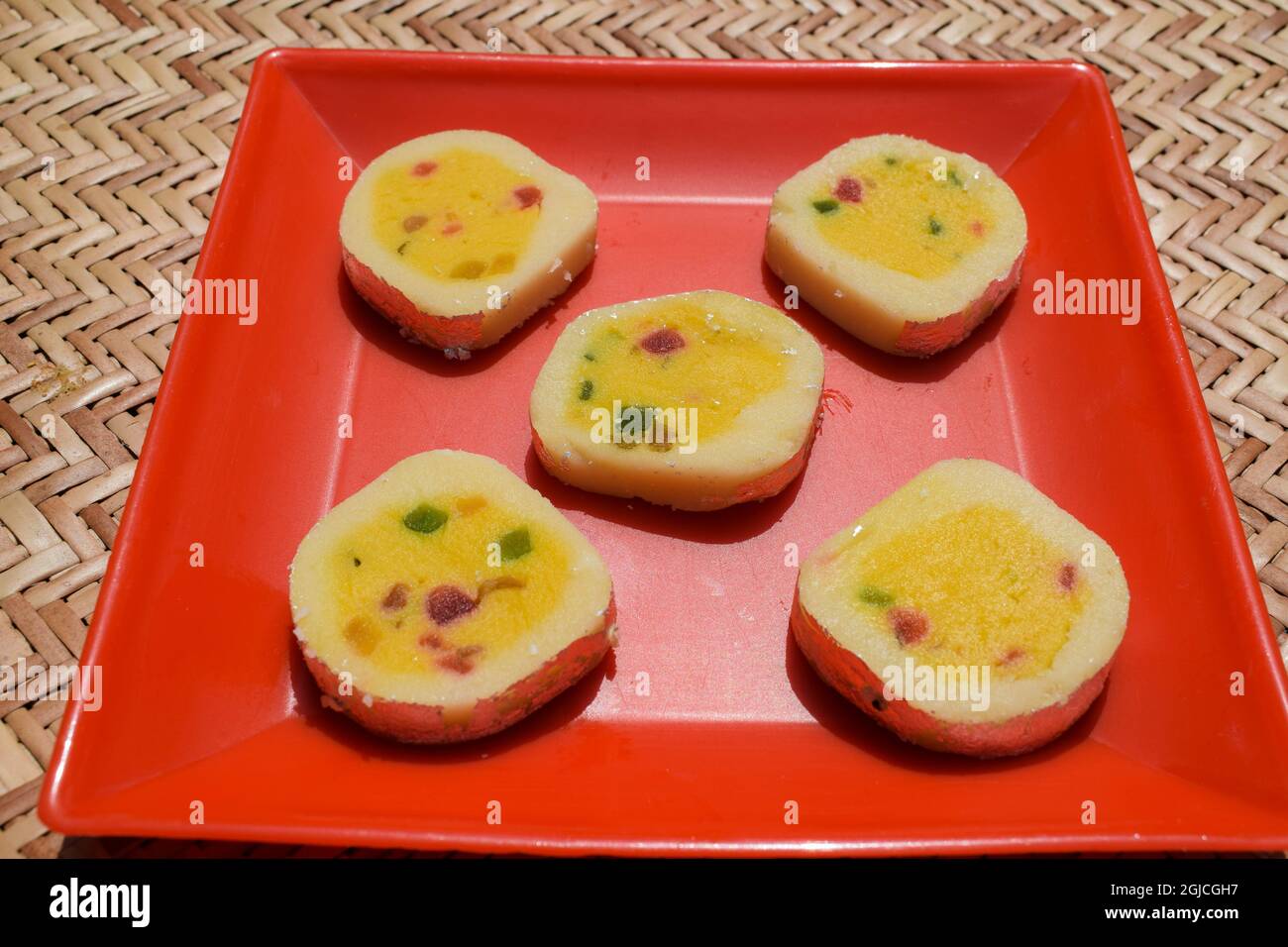 Indian sweet dish Tutti fruity Barfi rolls. With tutti frutti kesar ...