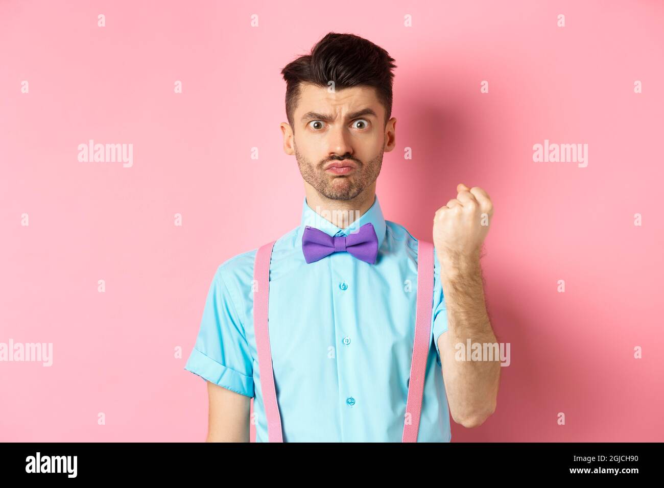 Silly man scolding someone, threaten person with fist, looking grumpy ...