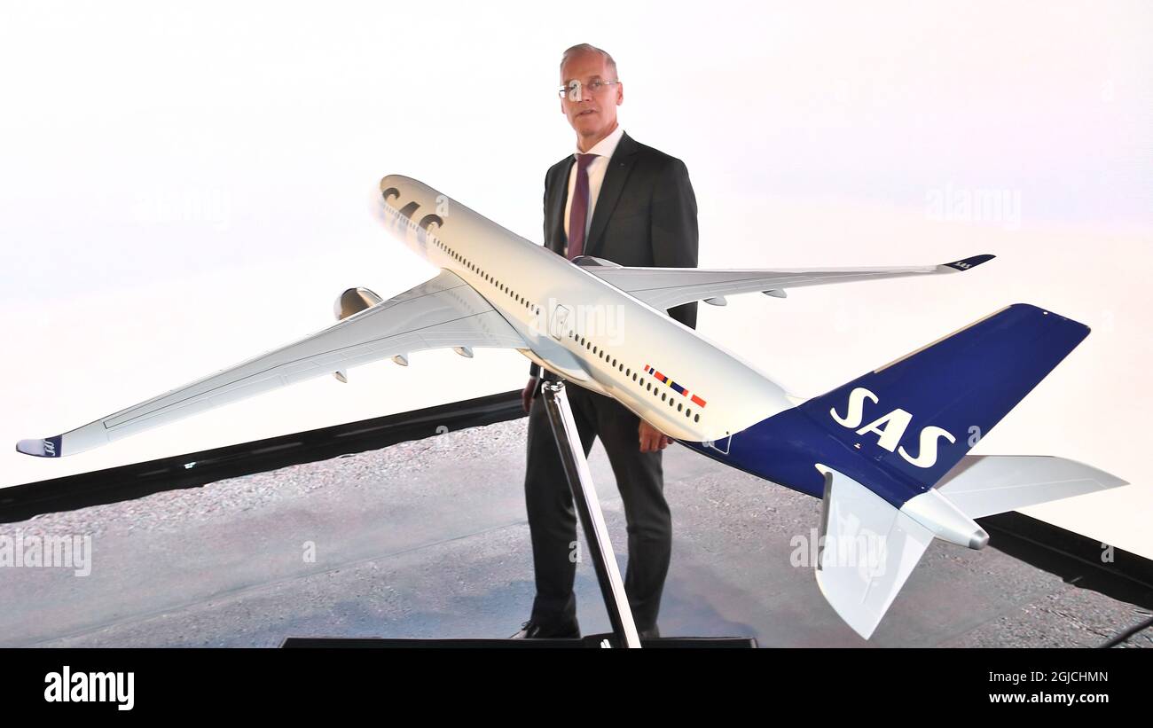 SAS CEO Rickard Gustafson pose by a model of an Airbus 350 with the ...
