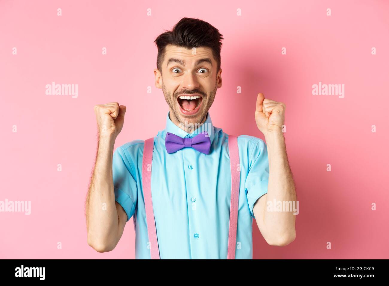 Happy guy winning prize, screaming with joy yes, shaking hands and ...