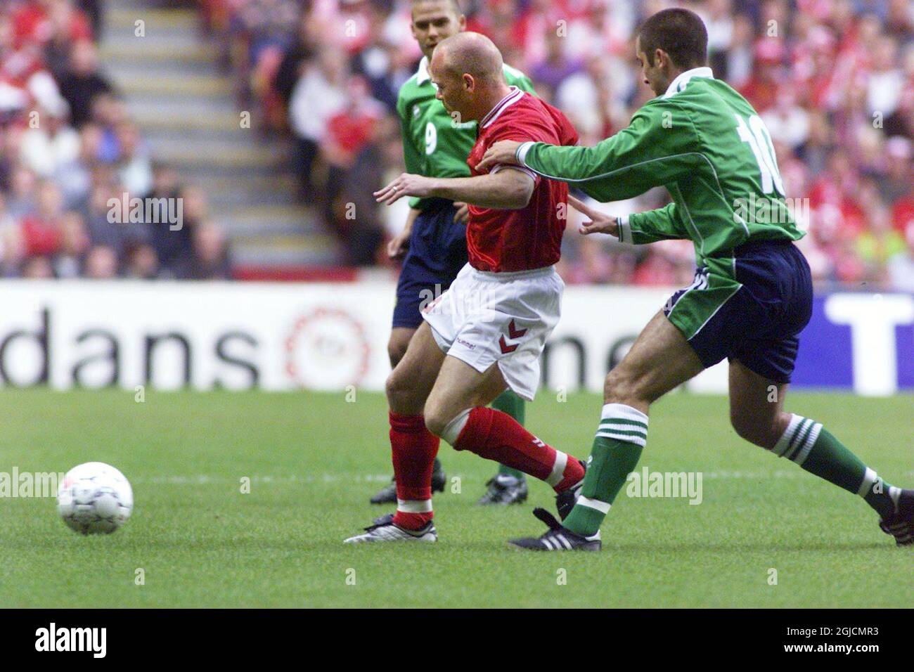 Northern Ireland's Kevin Horlock gets to grips with Denmark's Stig ...