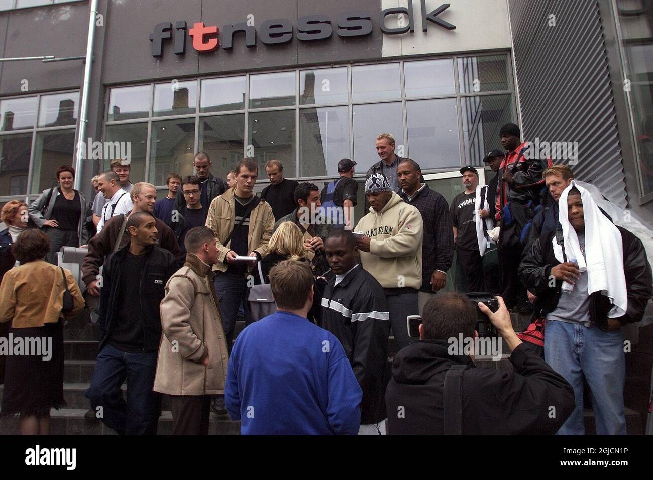 Mike Tyson signs autographs for fans after training at a gym in ...