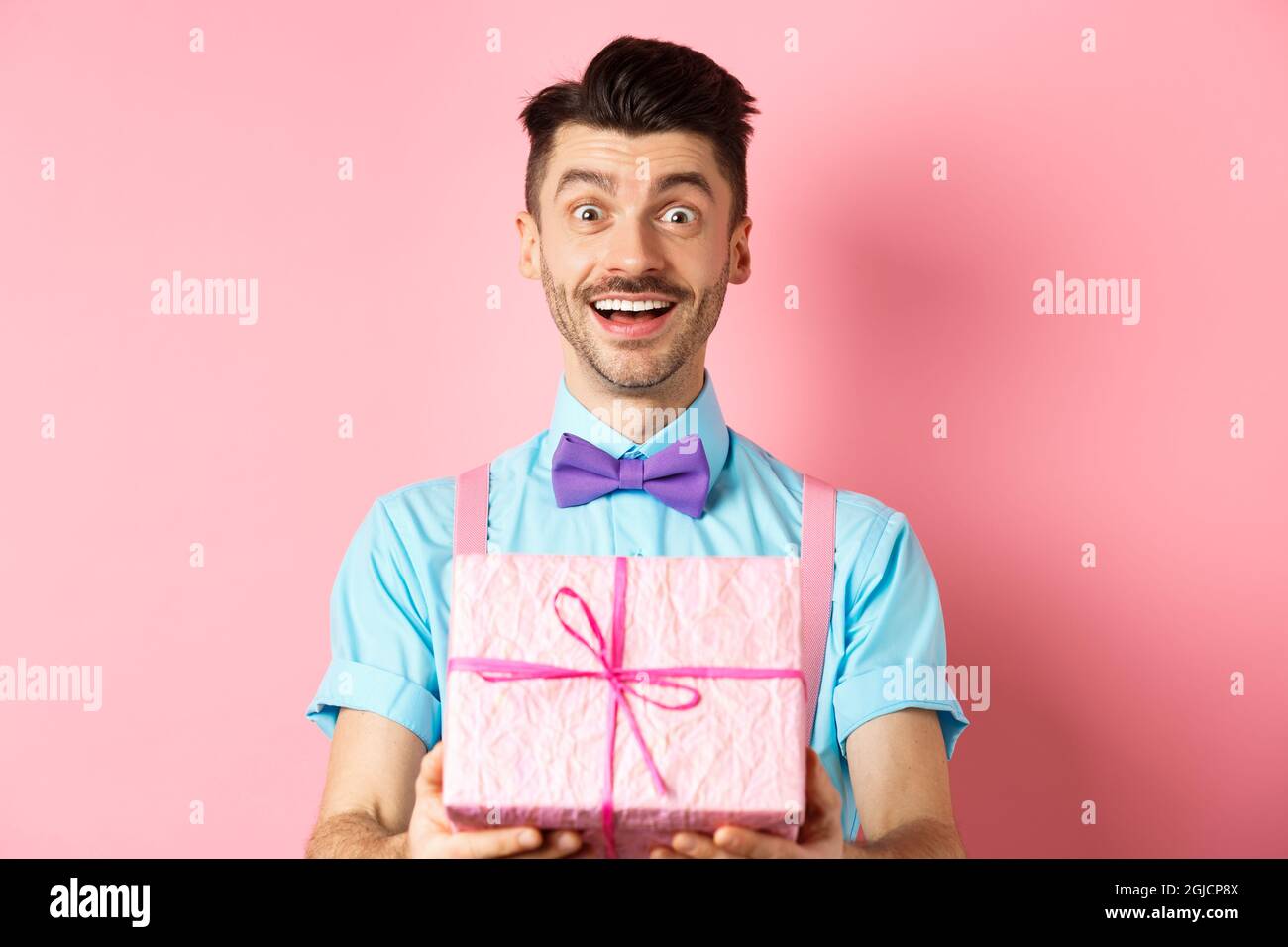 Holidays and celebration concept. Cheerful guy wishing happy birthday ...