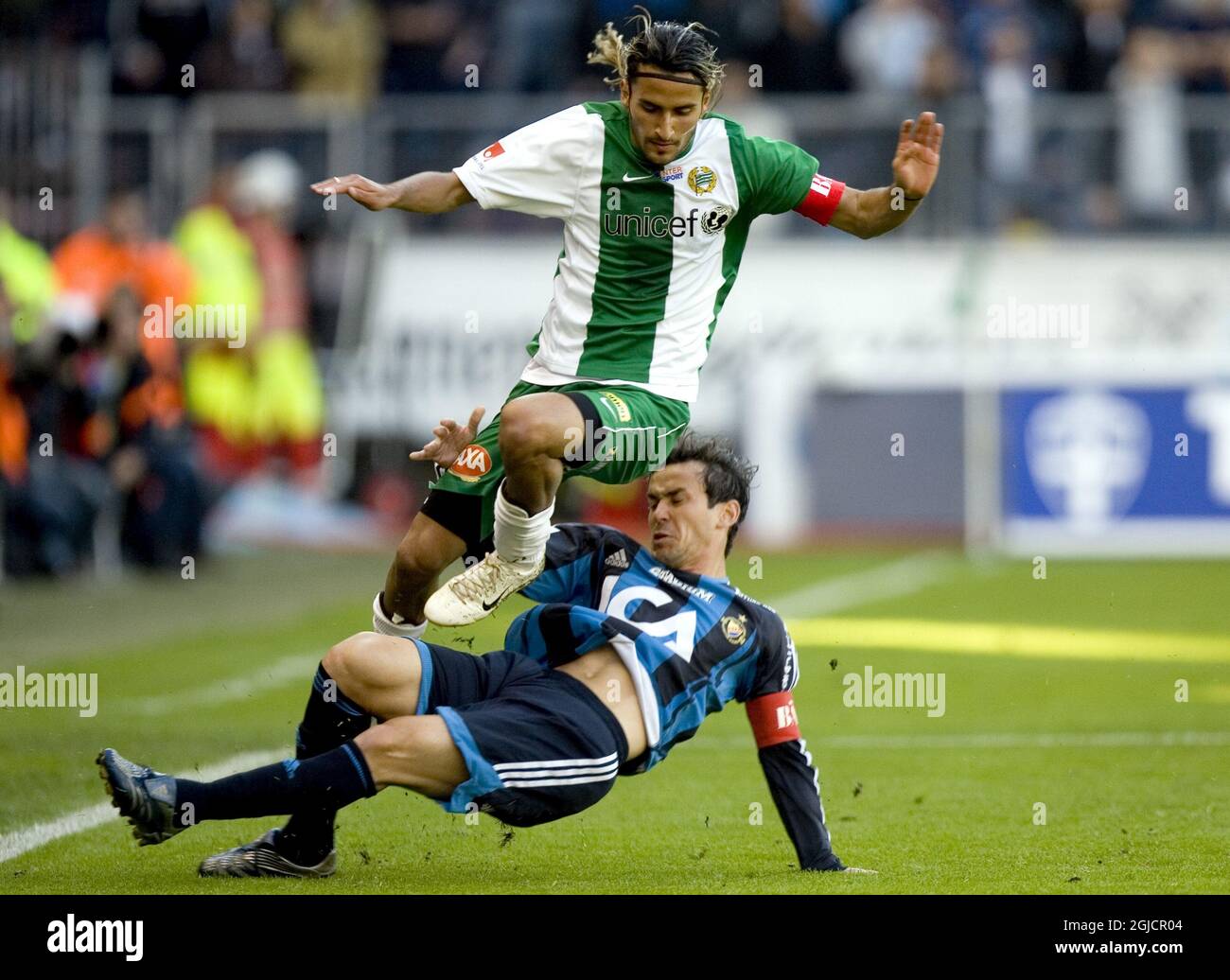 Hammarby's Erkan Zengin (top) hurdles the challenge of Djurgarden's ...