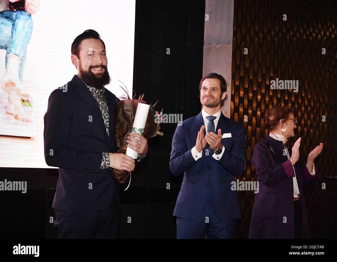STOCKHOLM 20191119 Swedish ceramist Alexander TallÃ©n (L) receives the ...