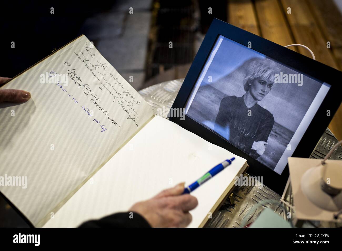 A fan signs the condolences book at a makeshift memorial for Swedish ...