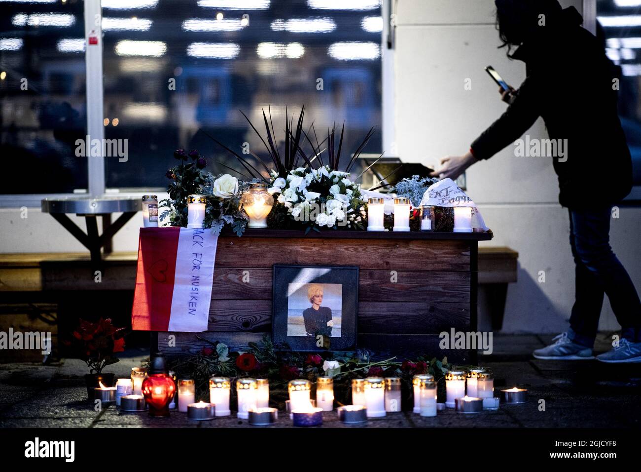 A fan takes pictures at a makeshift memorial for Swedish pop singer and ...