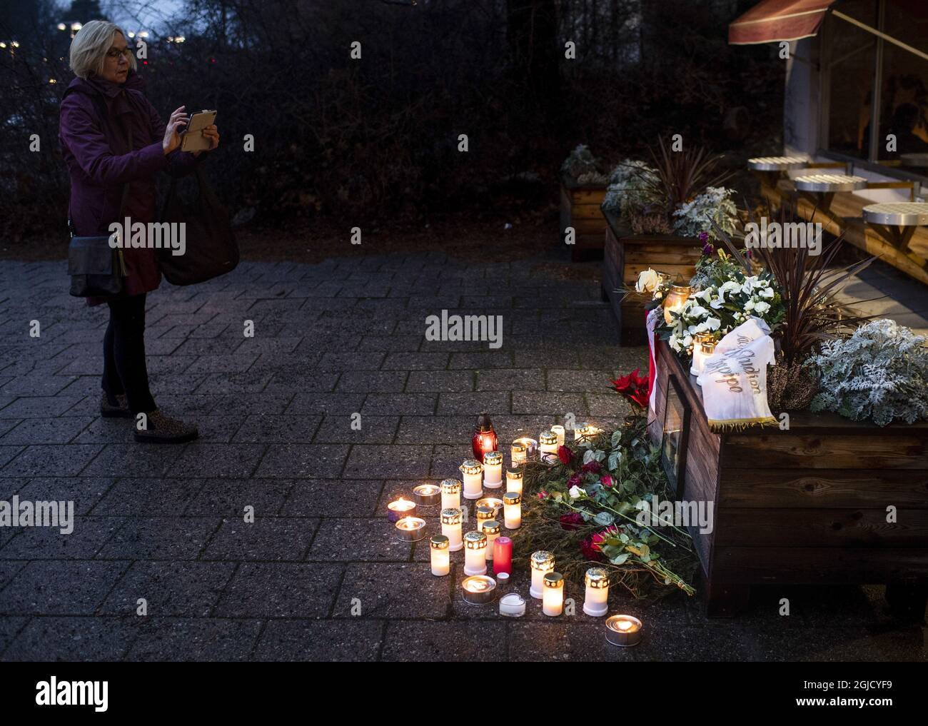A fan takes pictures at a makeshift memorial for Swedish pop singer and ...
