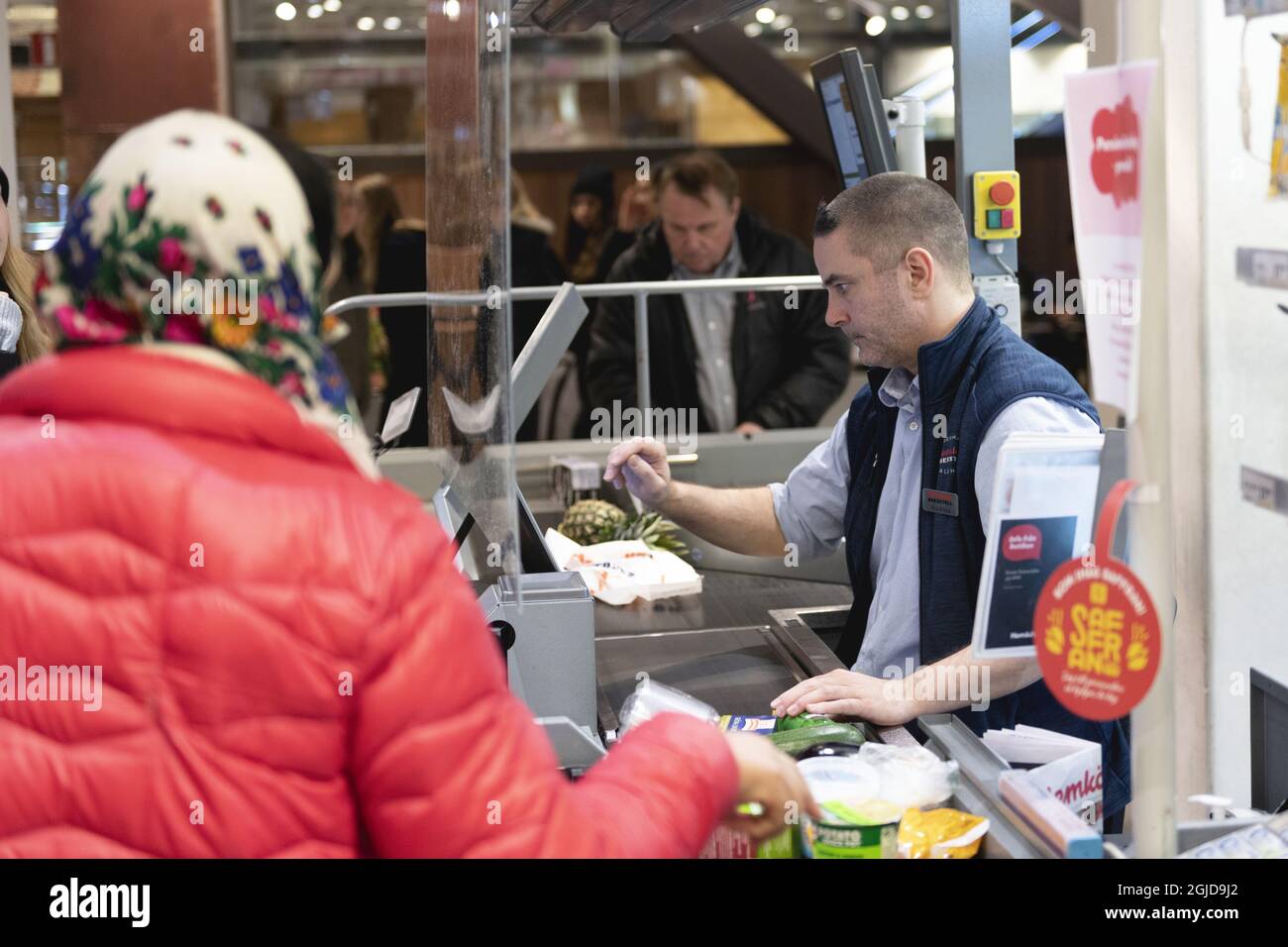 A picture taken on March 31, 2020, shows a cashier working from behind ...