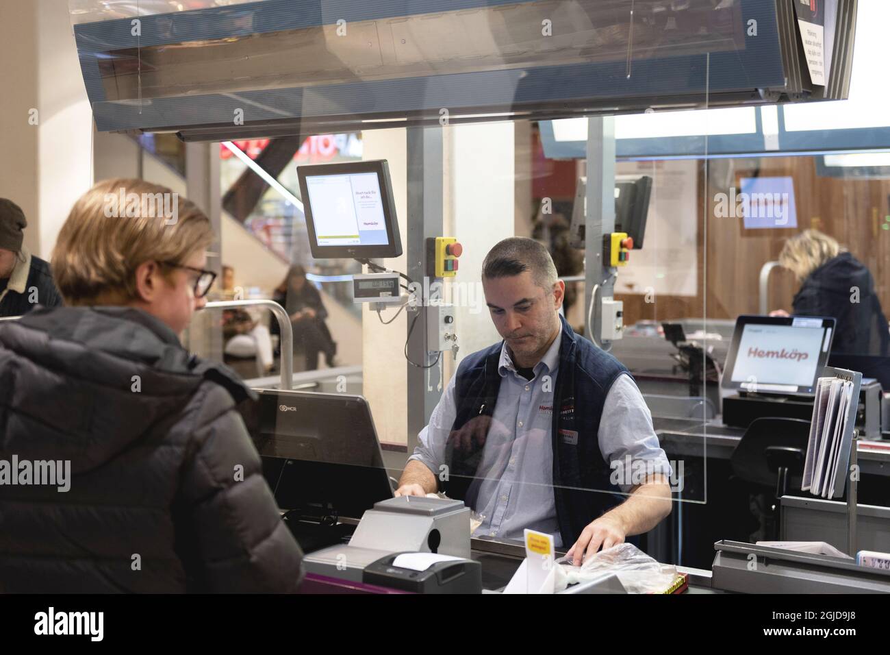 A picture taken on March 31, 2020, shows a cashier working from behind ...