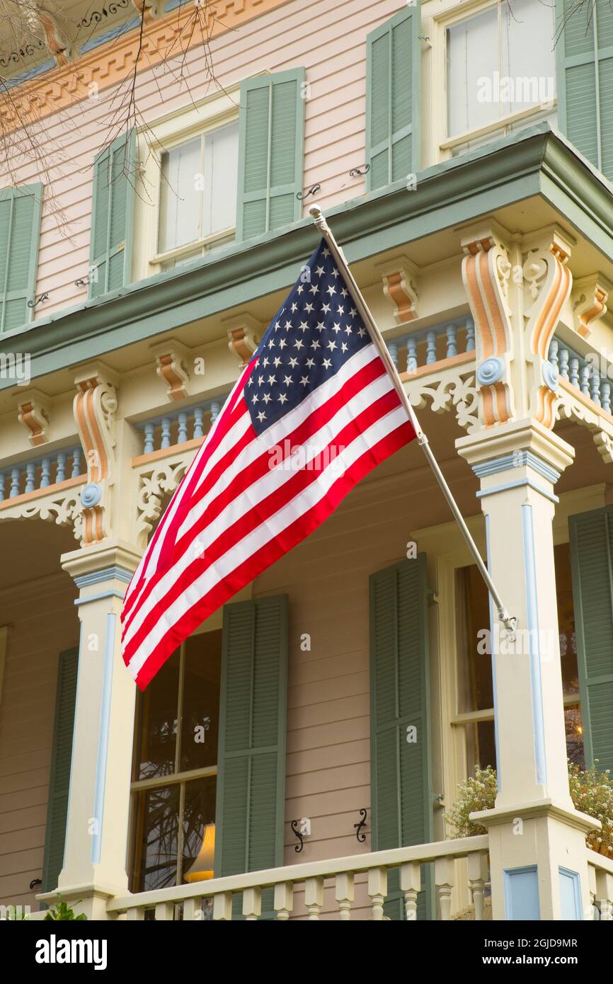 USA, Georgia, Savannah. US flag on a colorful house in the Victorian ...