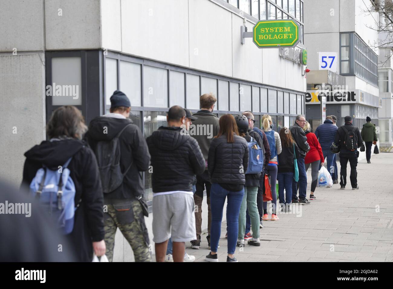 People queueing up outside the Swedish government-owned store ...