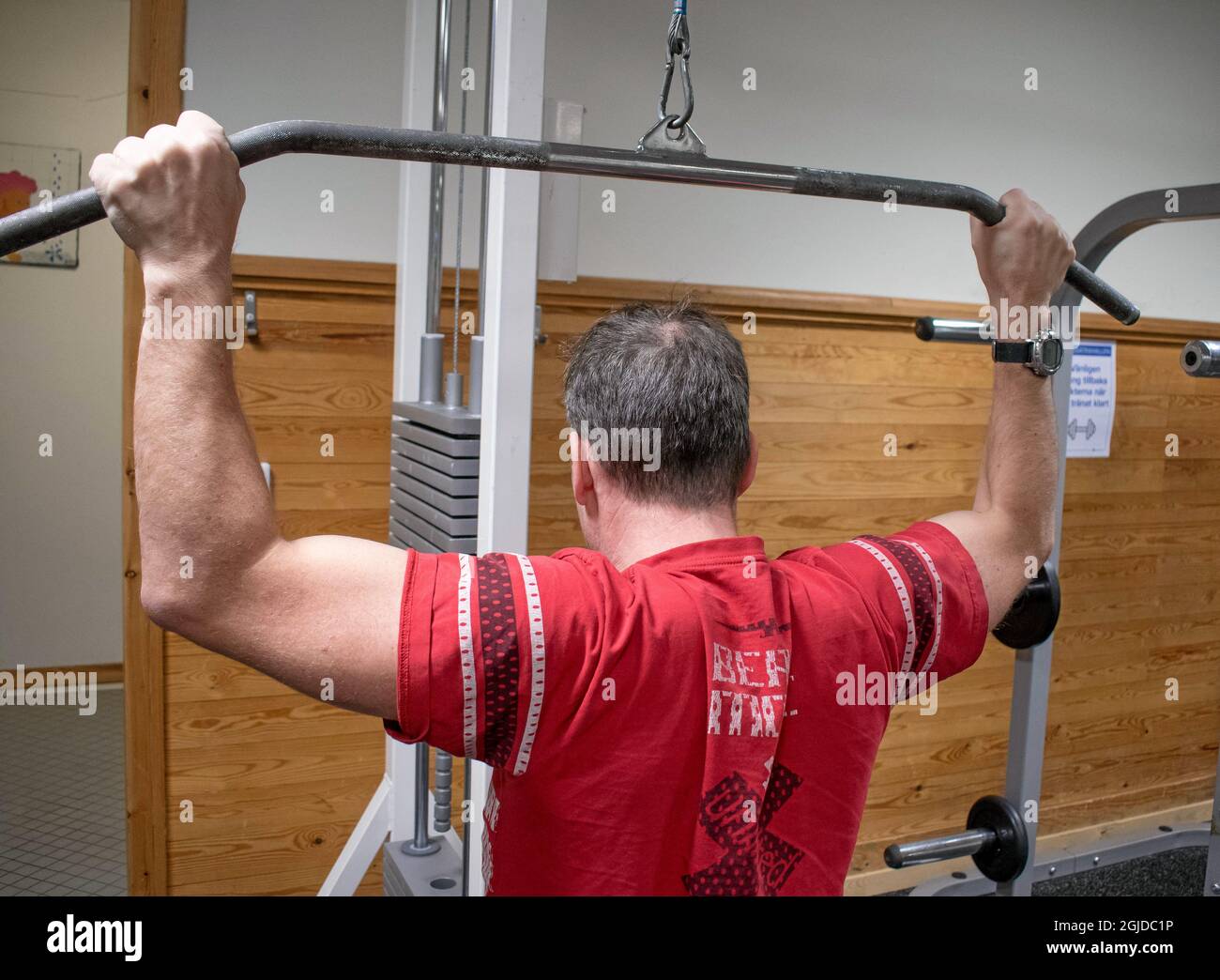 A man using a lat pull down machine during his workout. Photo: Henrik ...