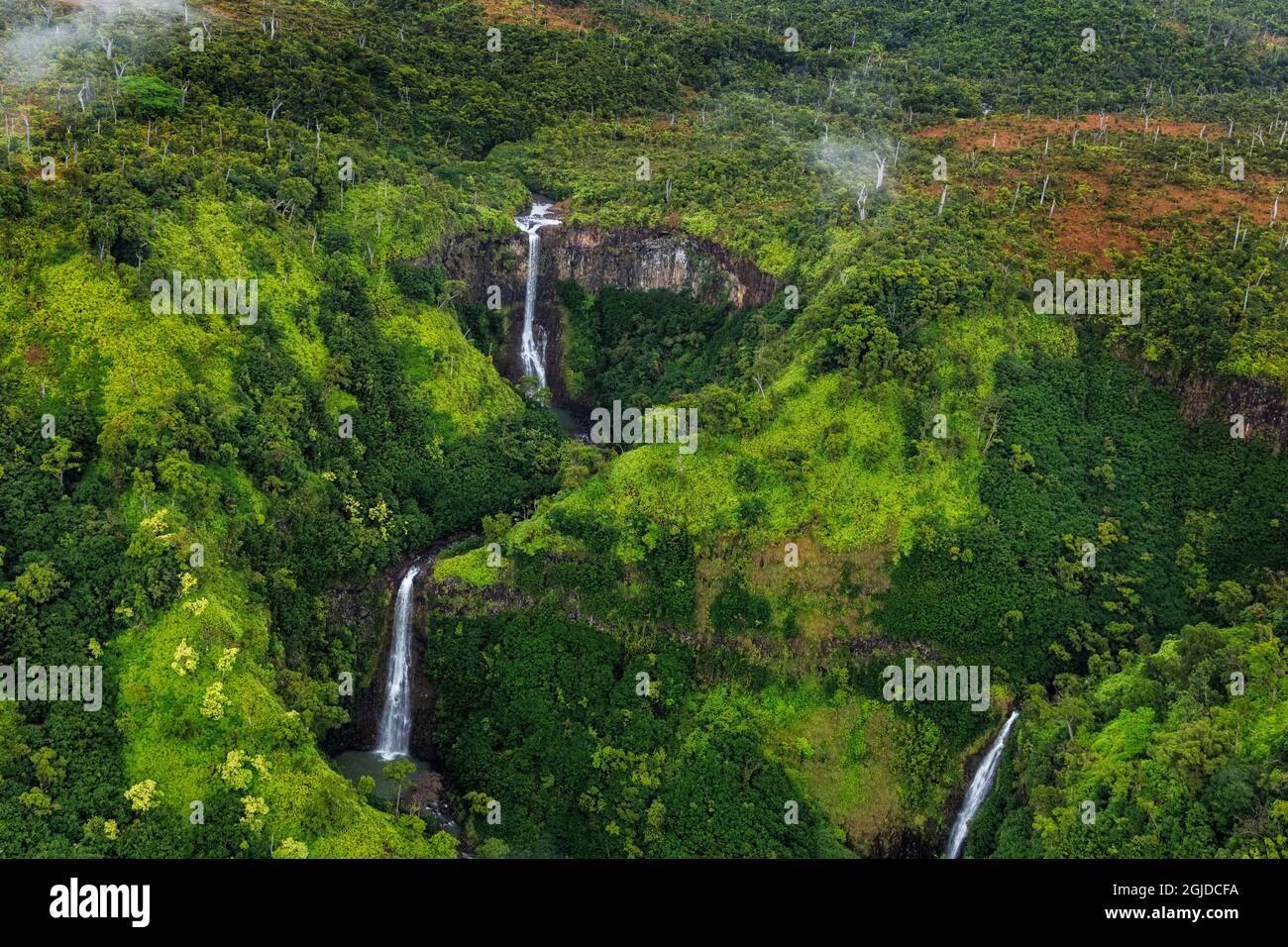 Lush Inland waterfalls during helicopter tour in Kauai, Hawaii, USA ...