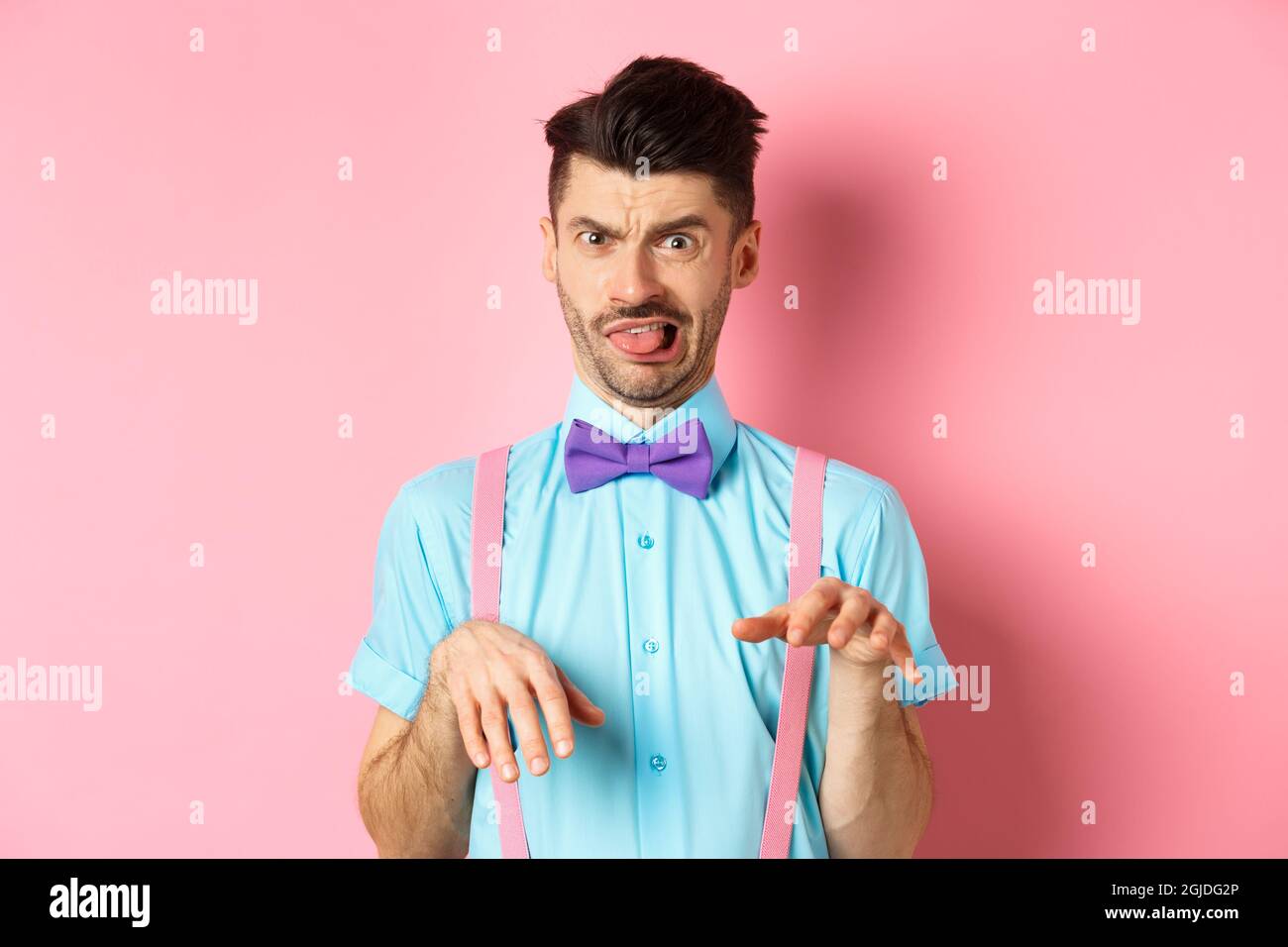 Funny guy looking at something disgusting with aversion and cringe ...