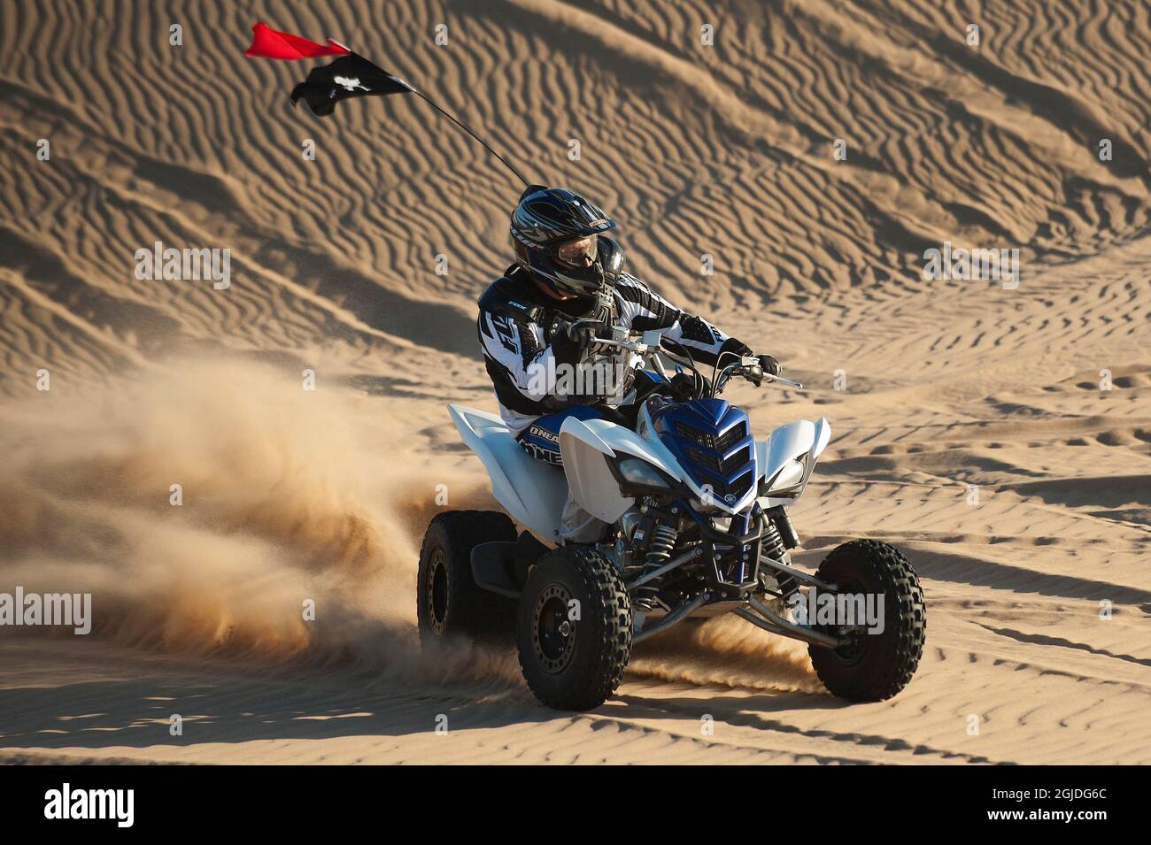 Motocross riding and Dune Atv Racing Stock Photo - Alamy