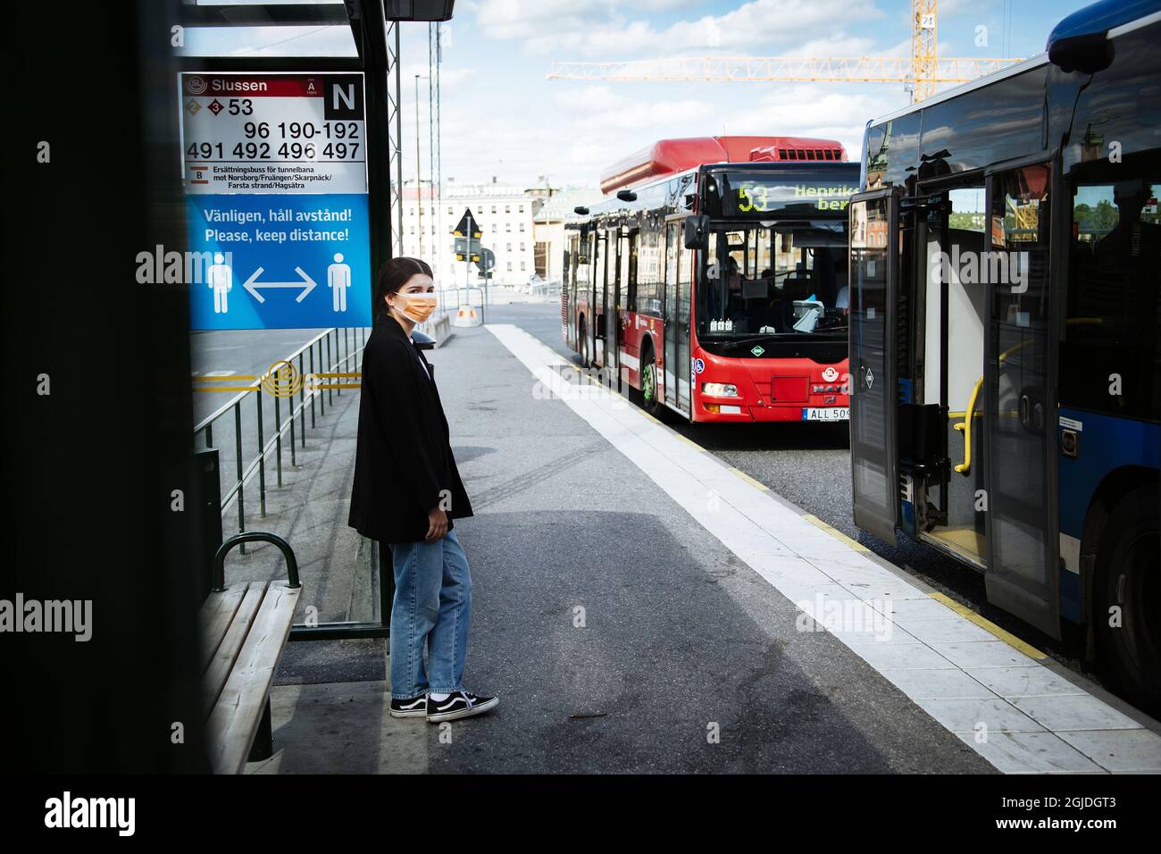 A young woman wearing a face mask, personal protective equipment (PPE ...