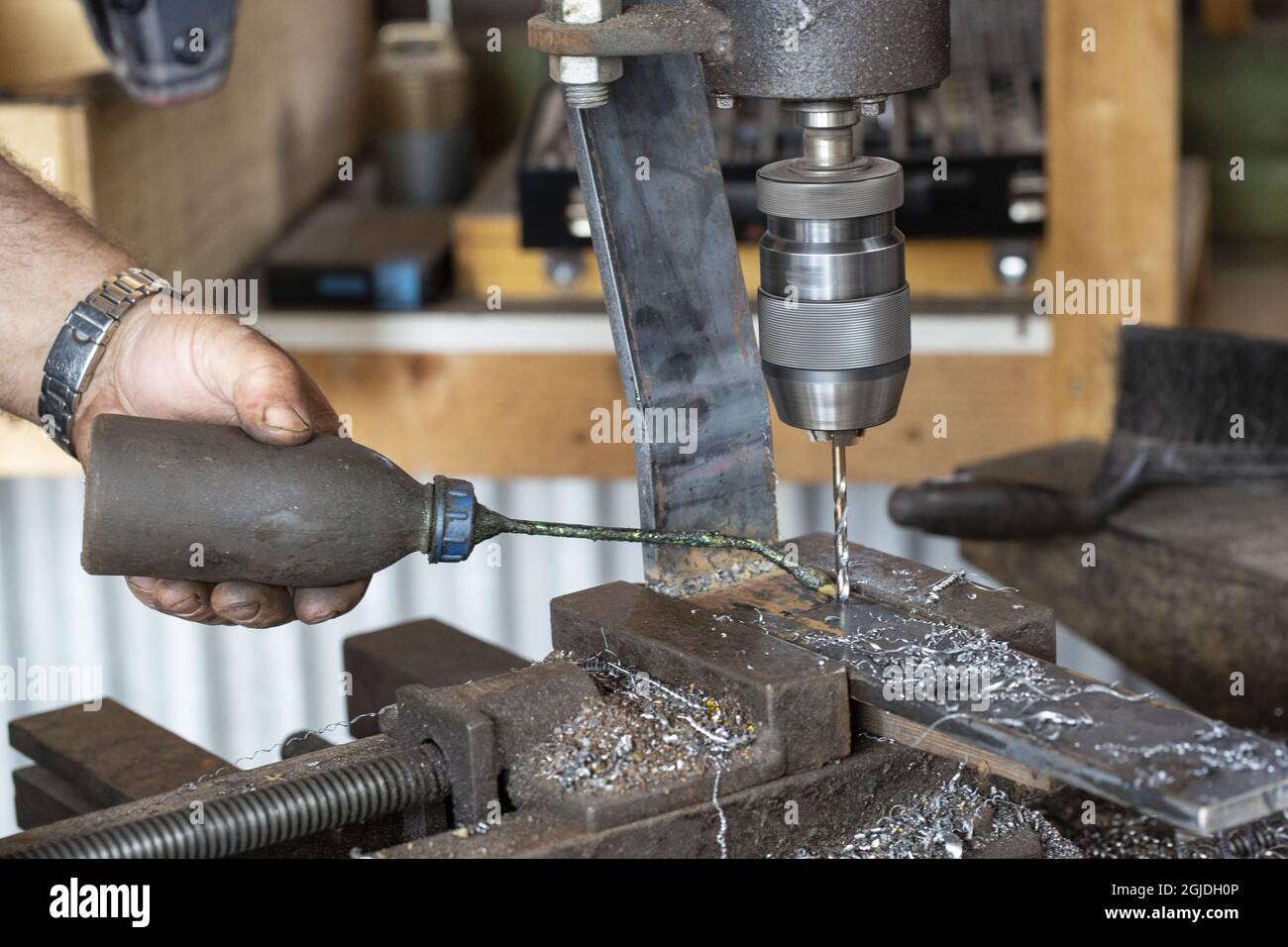 Man working a pillar drill in a workshop Photo: Fotograferna Holmberg ...