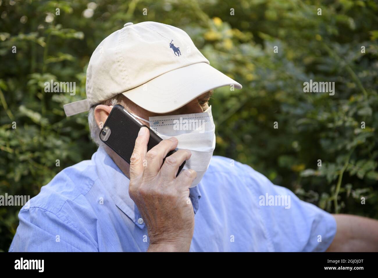 An elderly man (model) wearing personal protective equipment (PPE ...