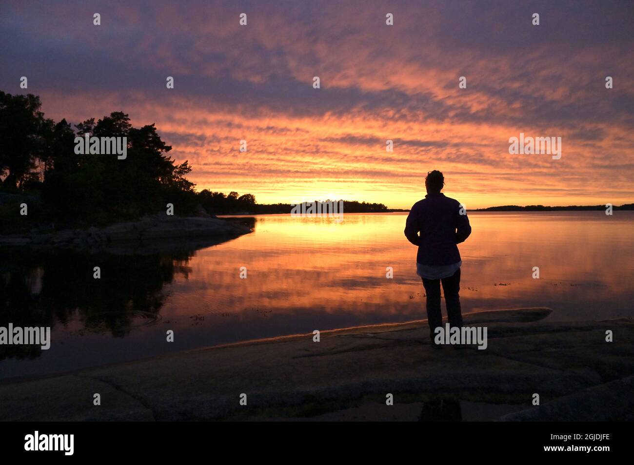 A woman in the sunset at Finnhamn in Stockholm archipelago. Photo ...
