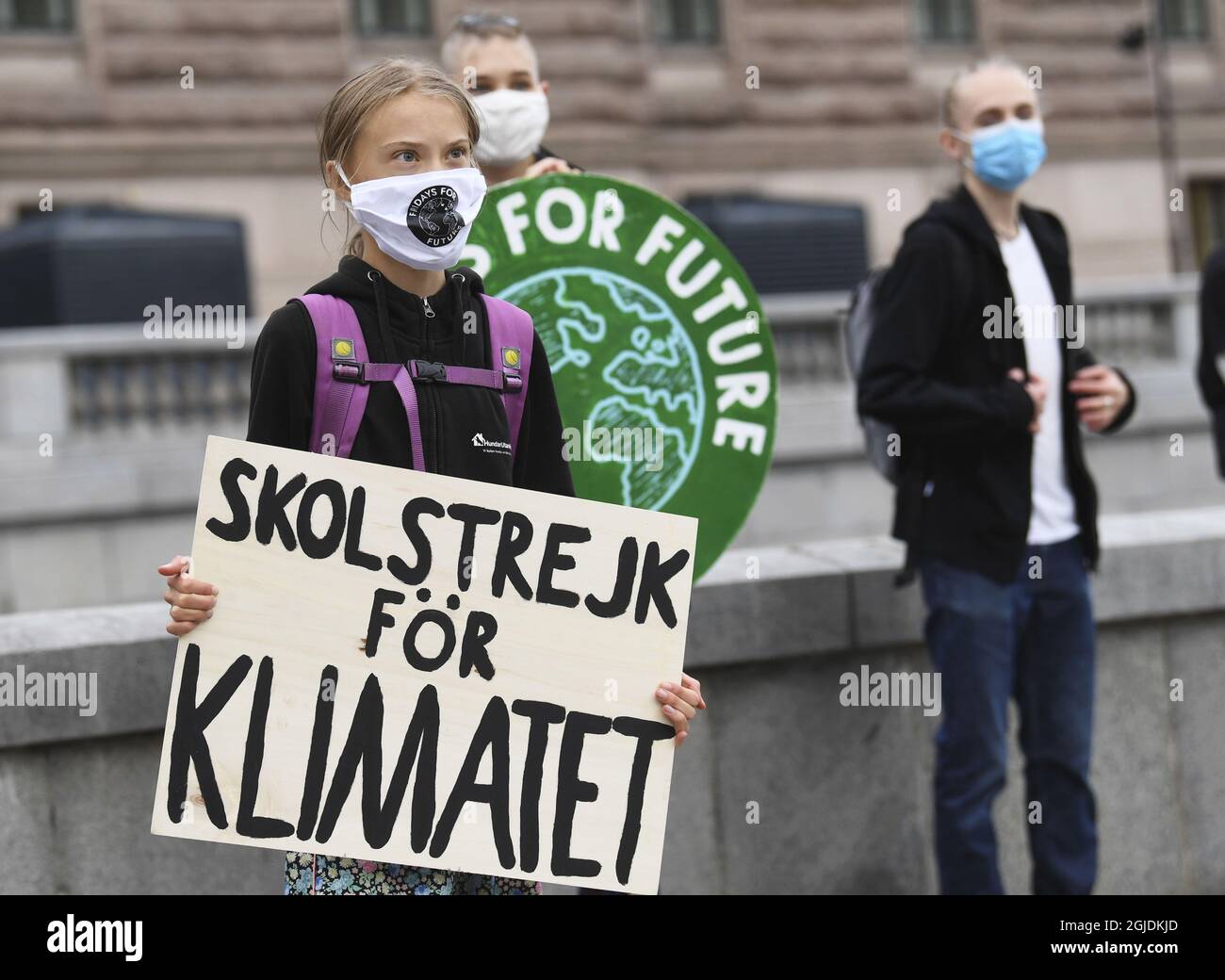 Swedish climate activist Greta Thunberg holds a poster reading "School ...