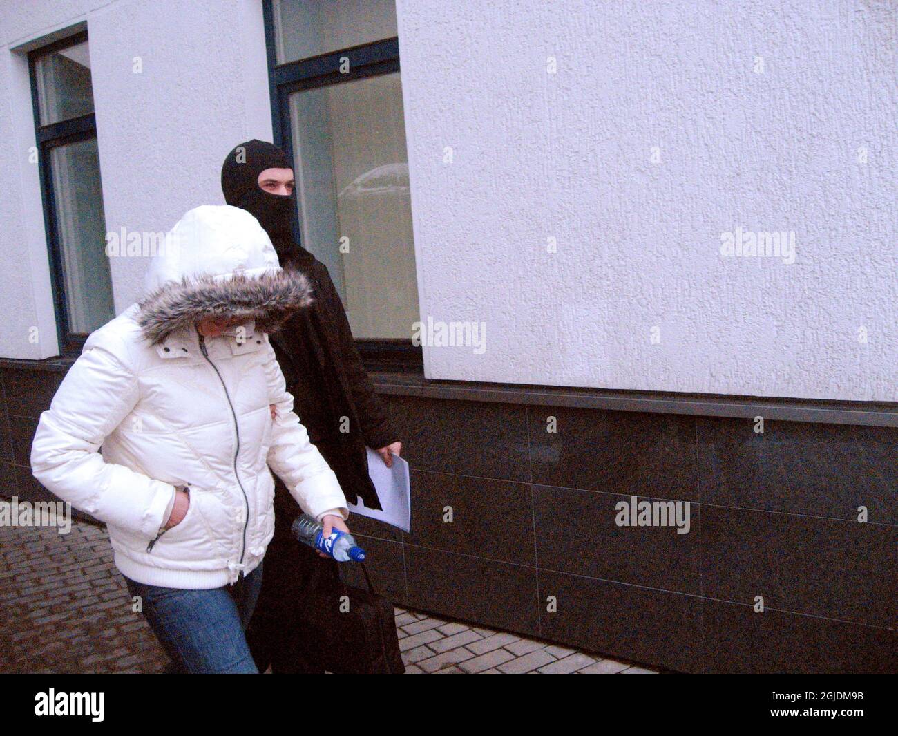 Unidentified woman is folowed by Lithuanian police officer after police ...