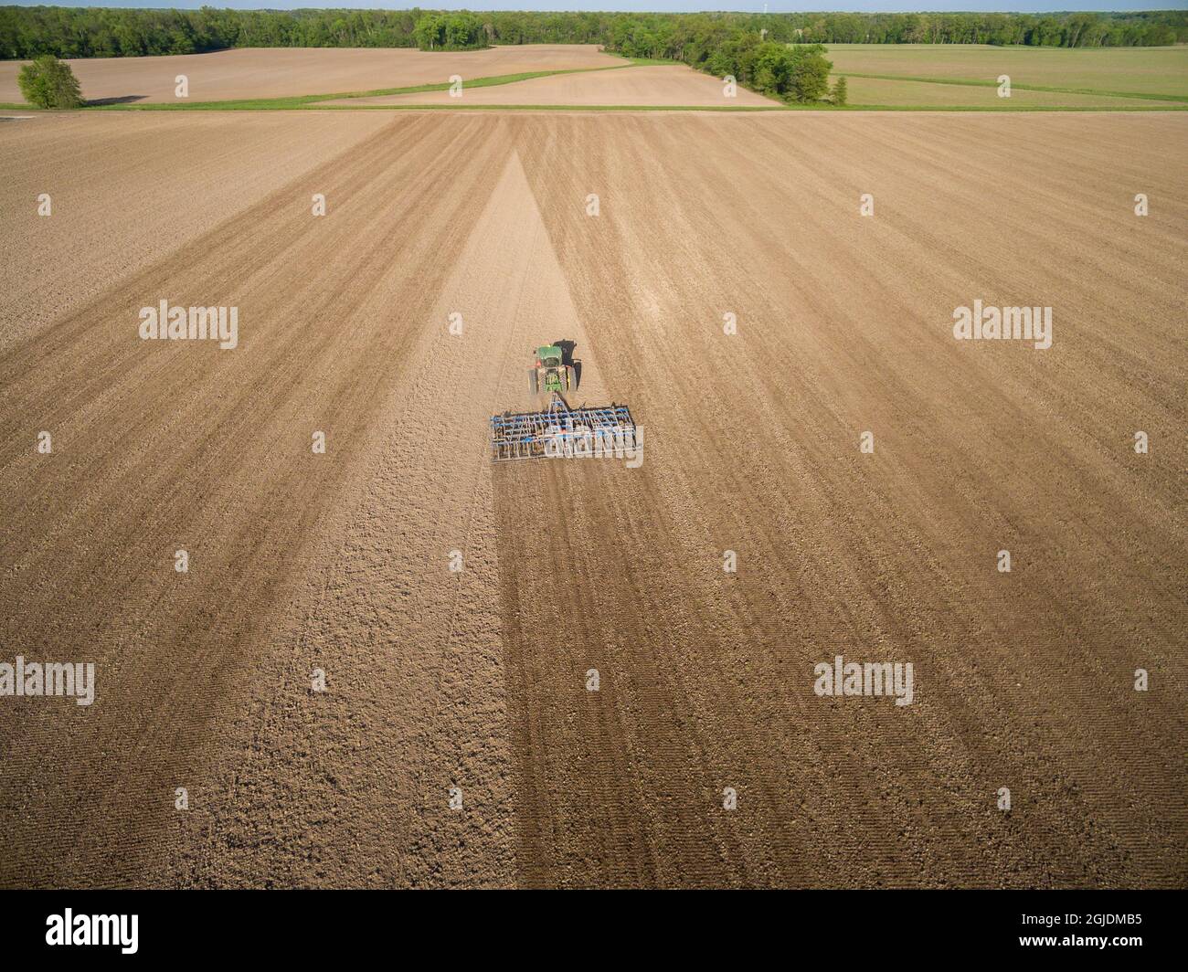 Farmer tilling field before planting corn. Marion County, Illinois, USA ...