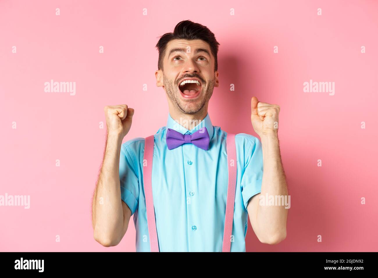 Relieved and happy man thanking god, looking up in sky while ...