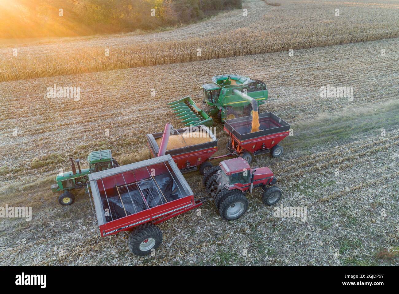 Aerial view of corn harvest combine unloading into grain cart, Marion ...
