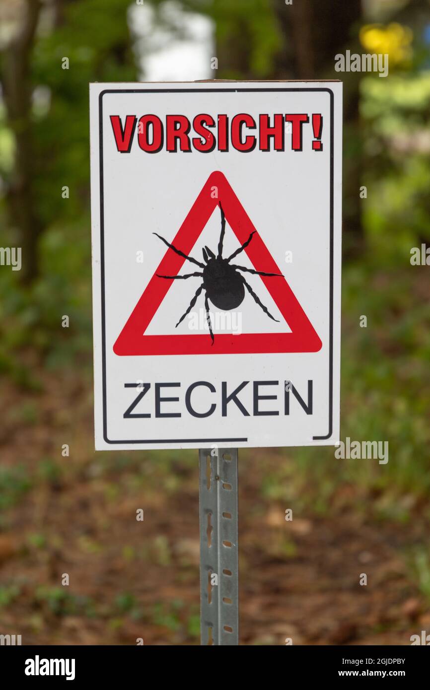 close-up of a warning sign in a forest with german inscription of ...