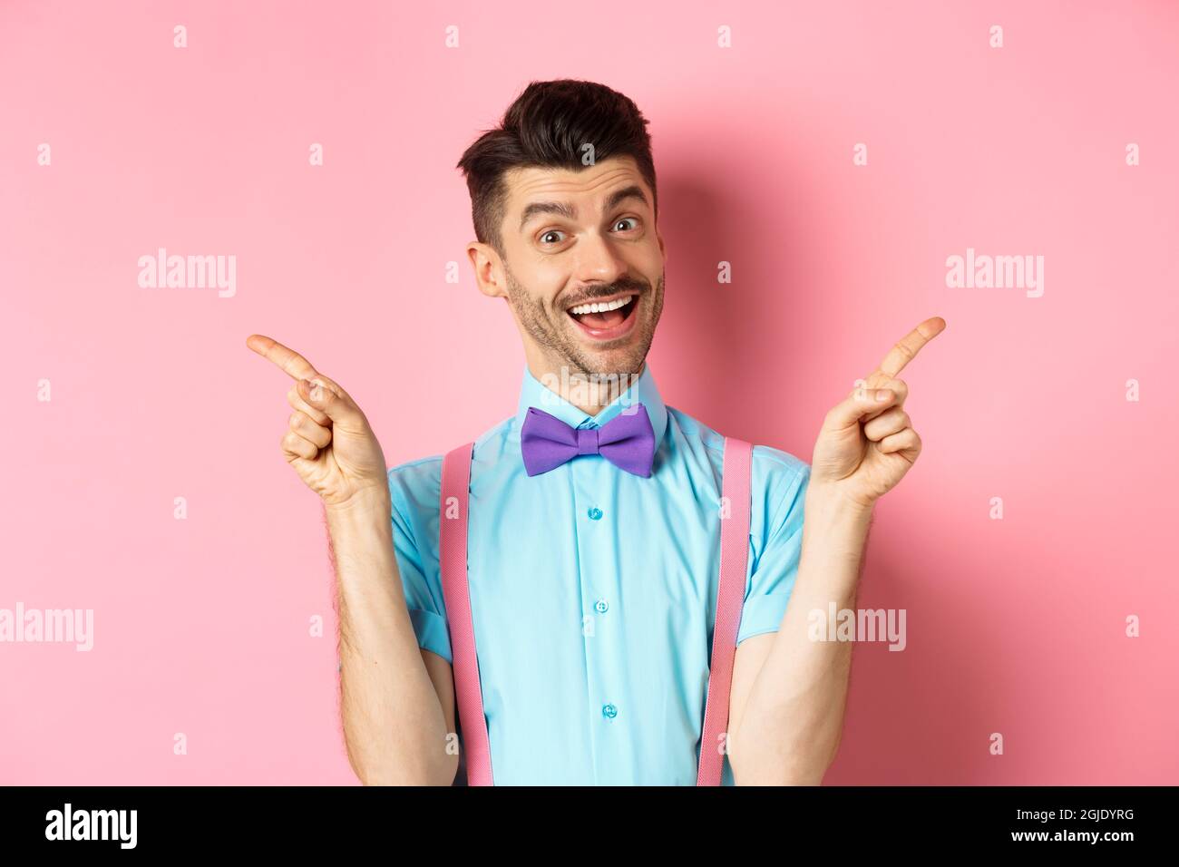 Handsome funny guy pointing fingers aside, showing left and right logo ...