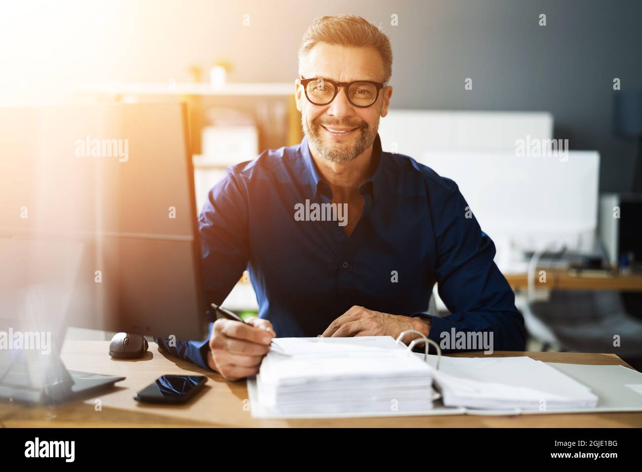 Man smiling desk hi-res stock photography and images - Alamy