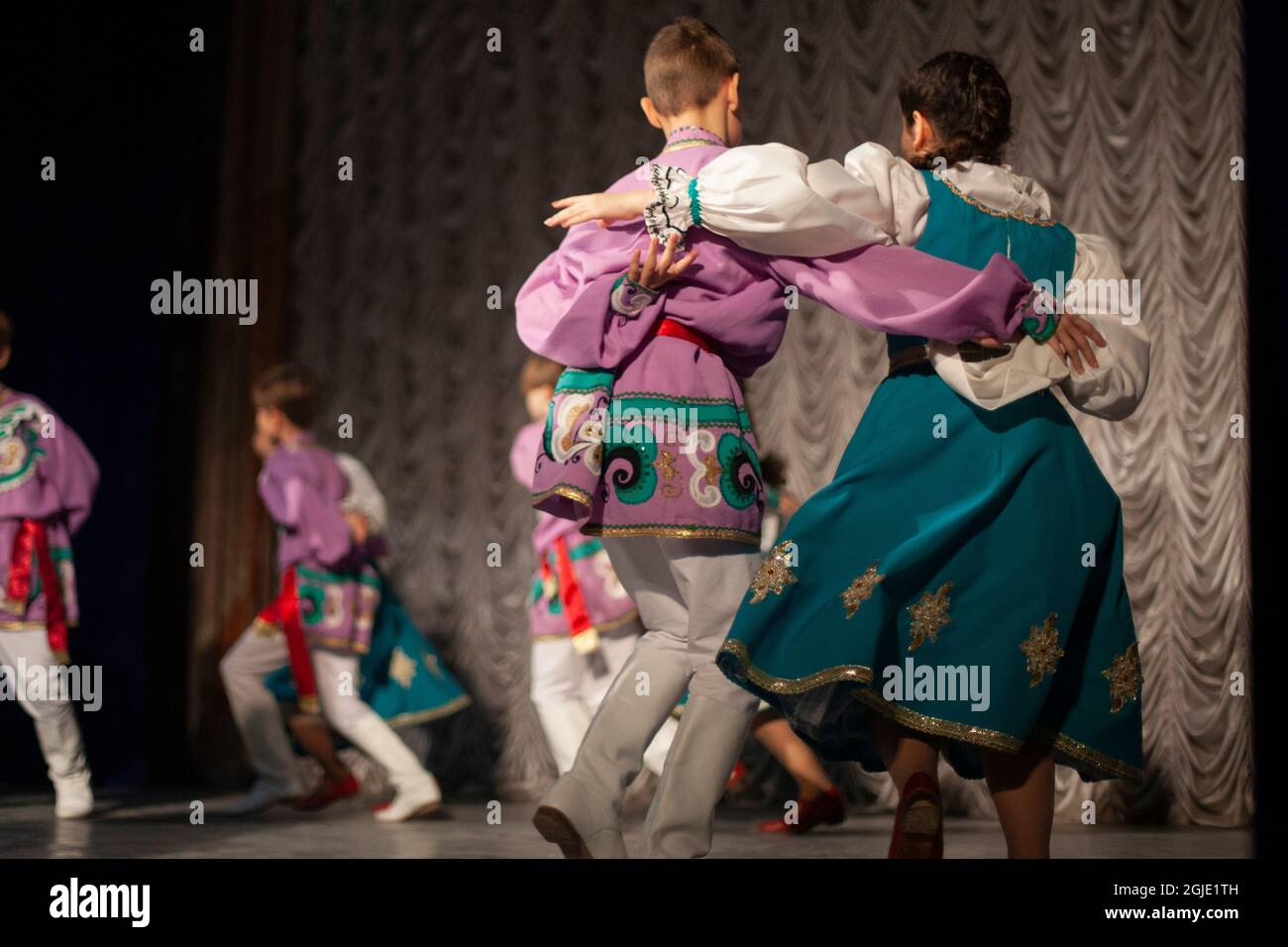 They dance in folk costumes. Russian children dance in sarafans ...