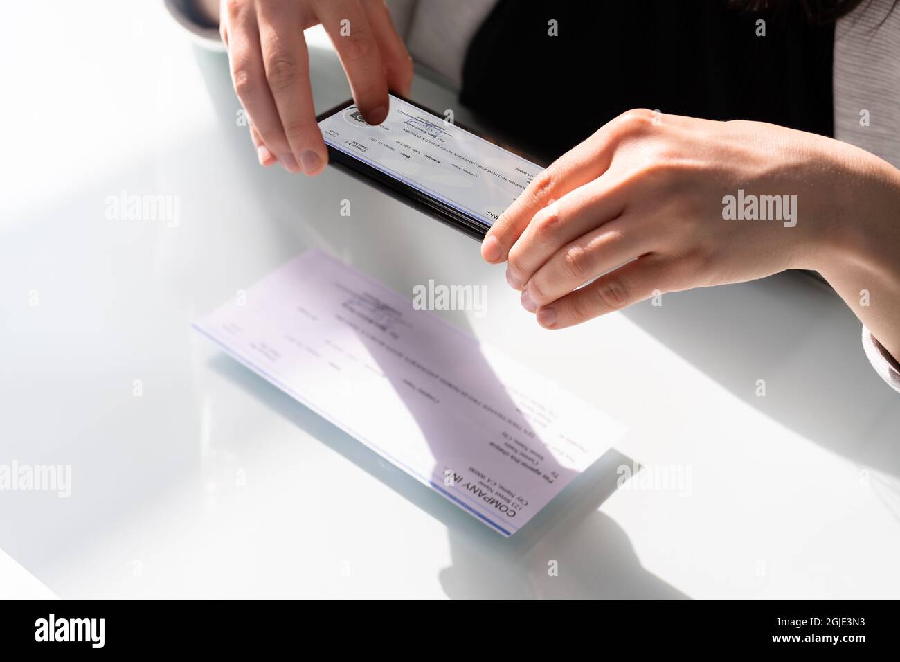 Remote Check Deposit Taking Photo With Mobile Phone Stock Photo - Alamy
