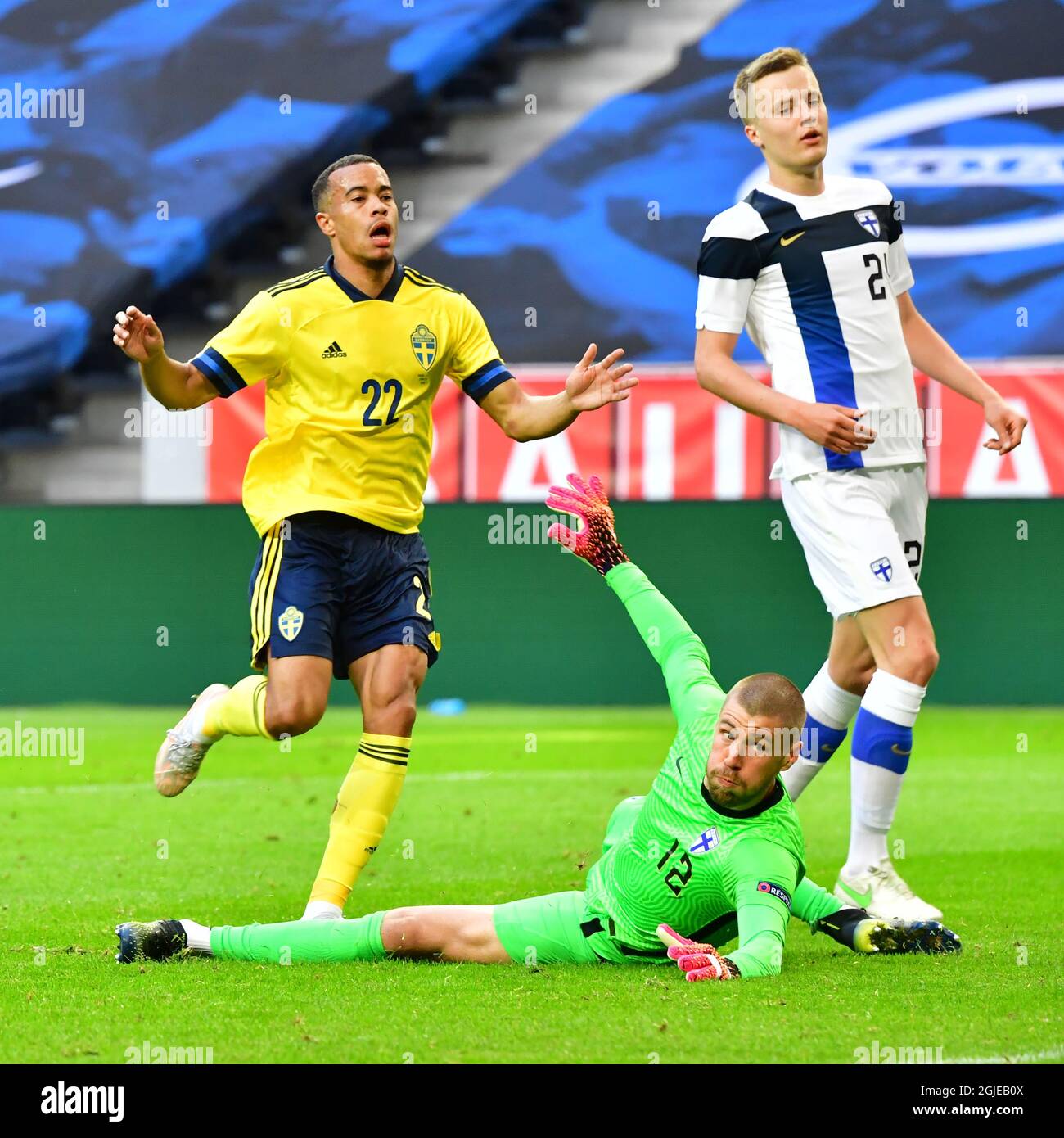 STOCKHOLM 20210529 Sweden's Robin Quaison scores Juhani Ojala (R) and ...