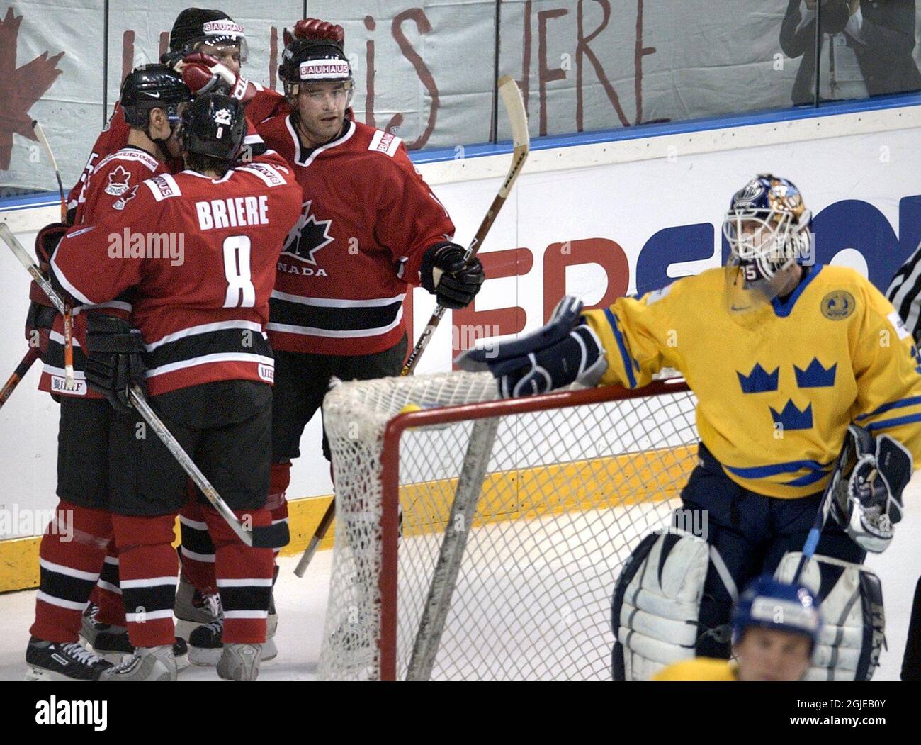 Canada players rush to congratulate teammate Dany Heatley (hidden) on ...