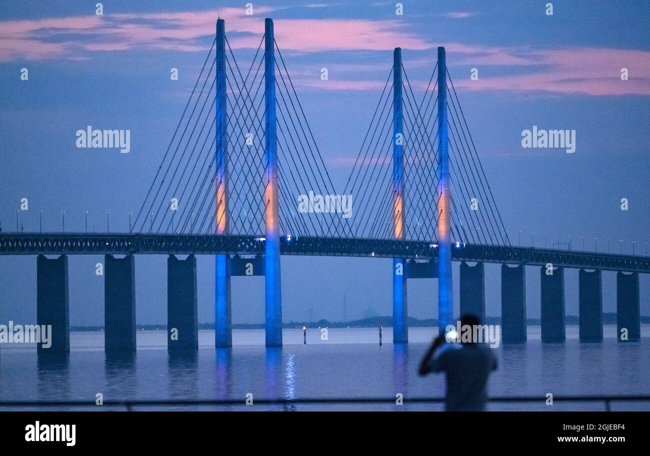 The 203.5 meter high pylons of the Oresund Bridge are lit up in the ...